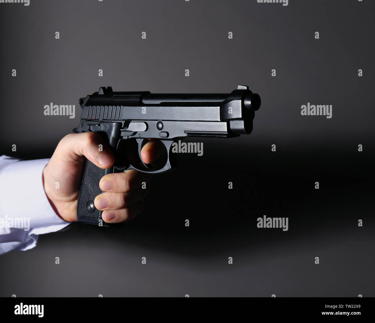 Mans hand holding gun hi-res stock photography and images - Alamy