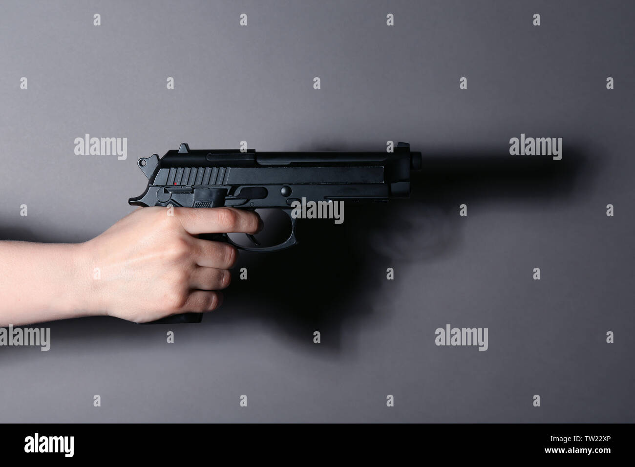 Mans hand holding gun hi-res stock photography and images - Alamy