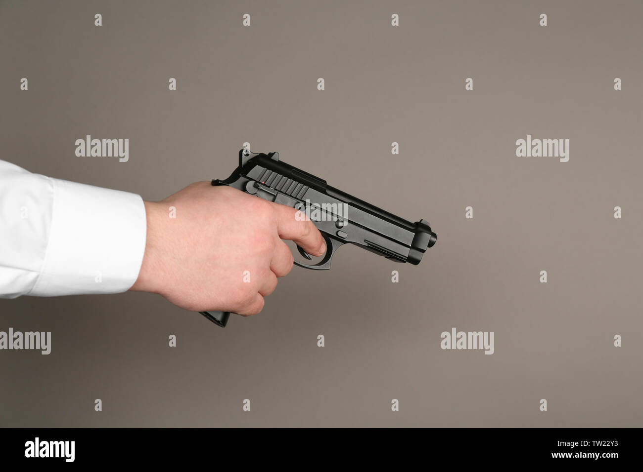 Mans hand holding gun hi-res stock photography and images - Alamy
