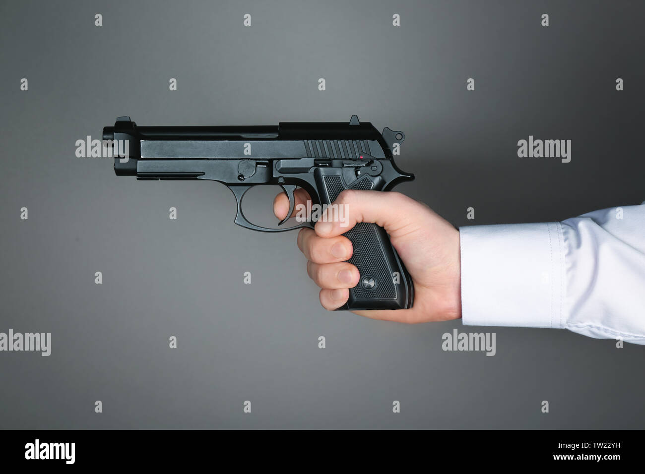 Mans hand holding gun hi-res stock photography and images - Alamy