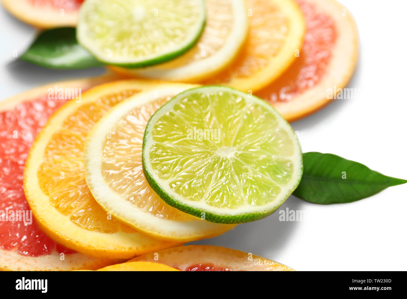 Fresh slices of citrus fruits on white background Stock Photo - Alamy