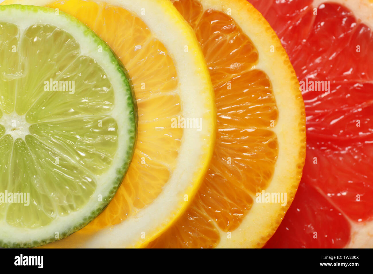 Four slices of citrus fruits, closeup Stock Photo - Alamy