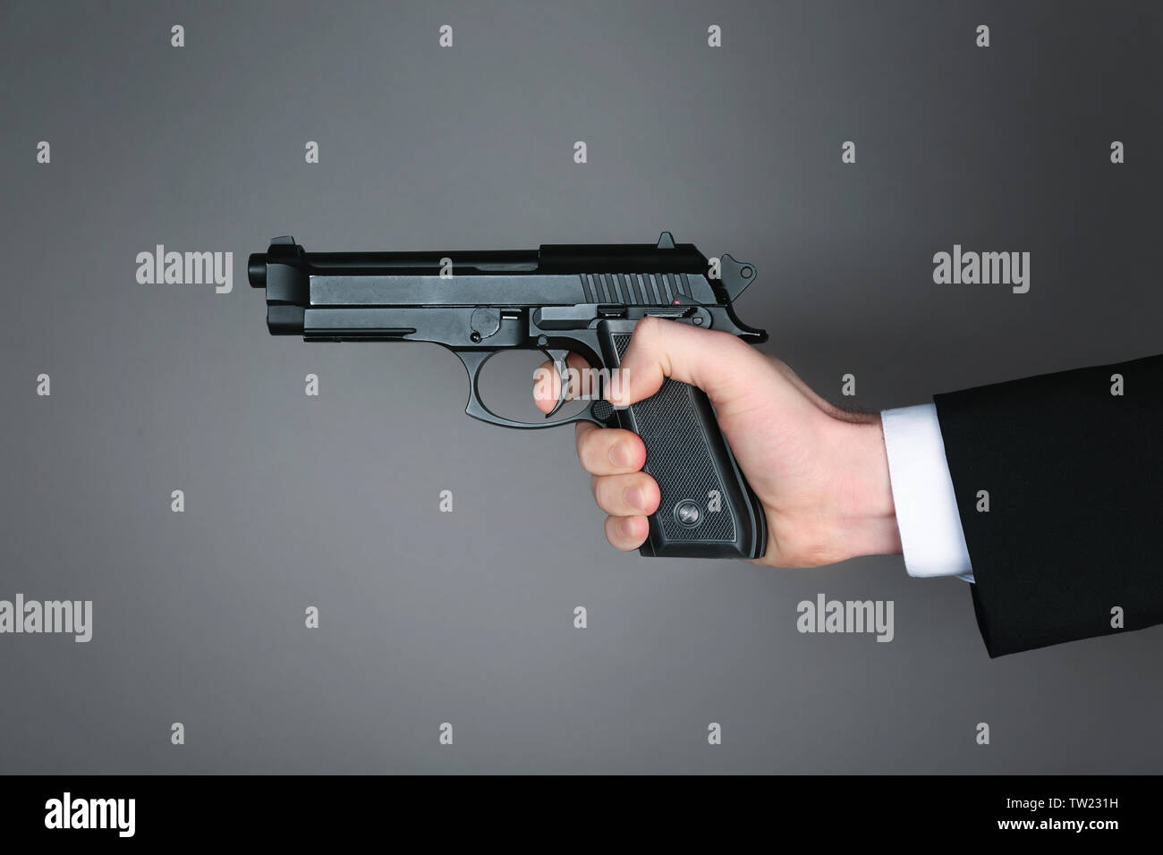Mans hand holding gun hi-res stock photography and images - Alamy