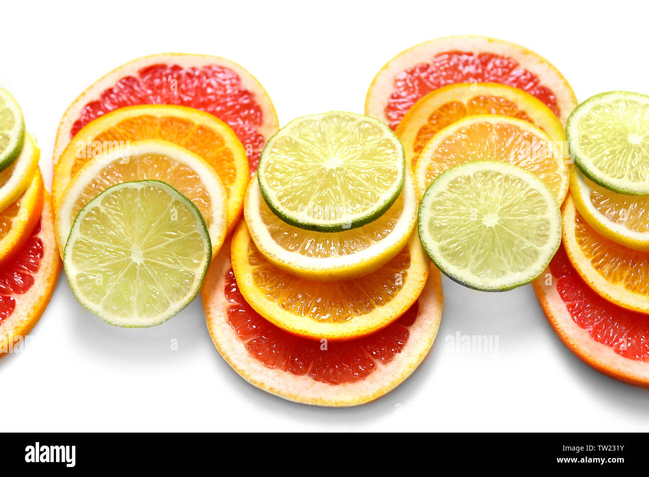 Fresh slices of citrus fruits on white background Stock Photo - Alamy
