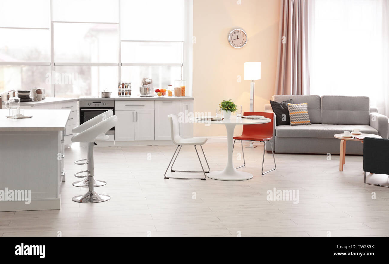 Modern kitchen interior of studio apartment with white round table ...
