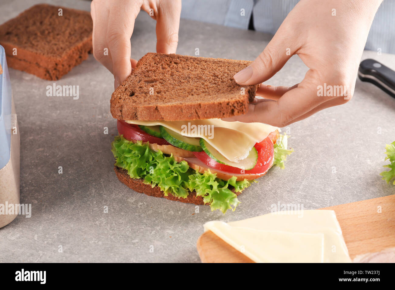 Mother preparing sandwich for school lunch on table Stock Photo - Alamy