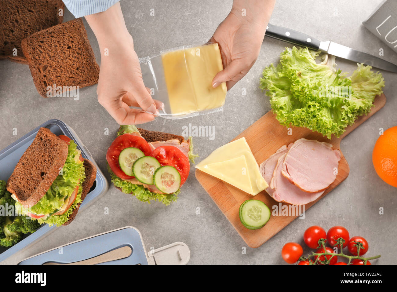 Mother preparing sandwich for school lunch on table Stock Photo - Alamy