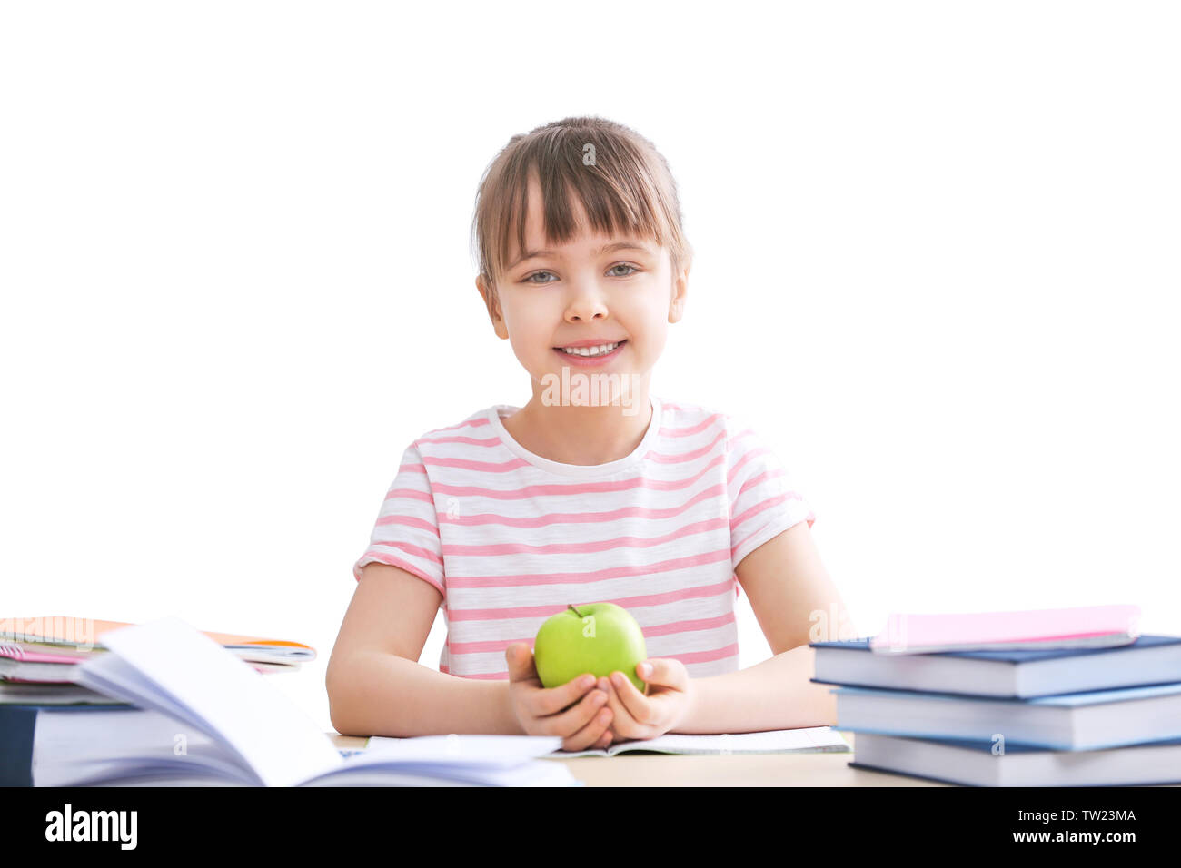 Happy schoolgirl studying at table on white background Stock Photo - Alamy
