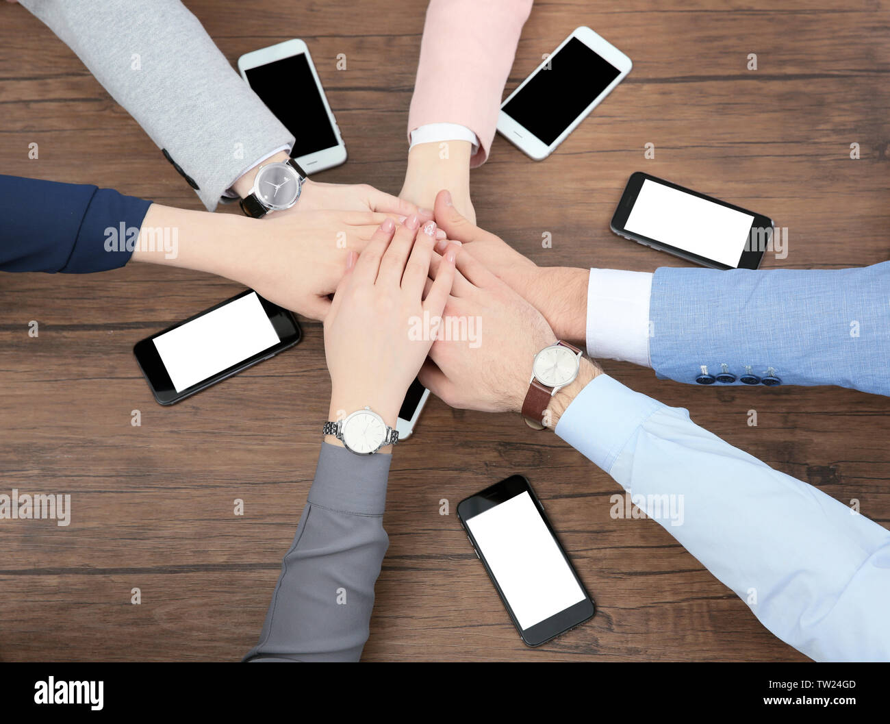 Team work concept. People sitting at table and holding hands together ...