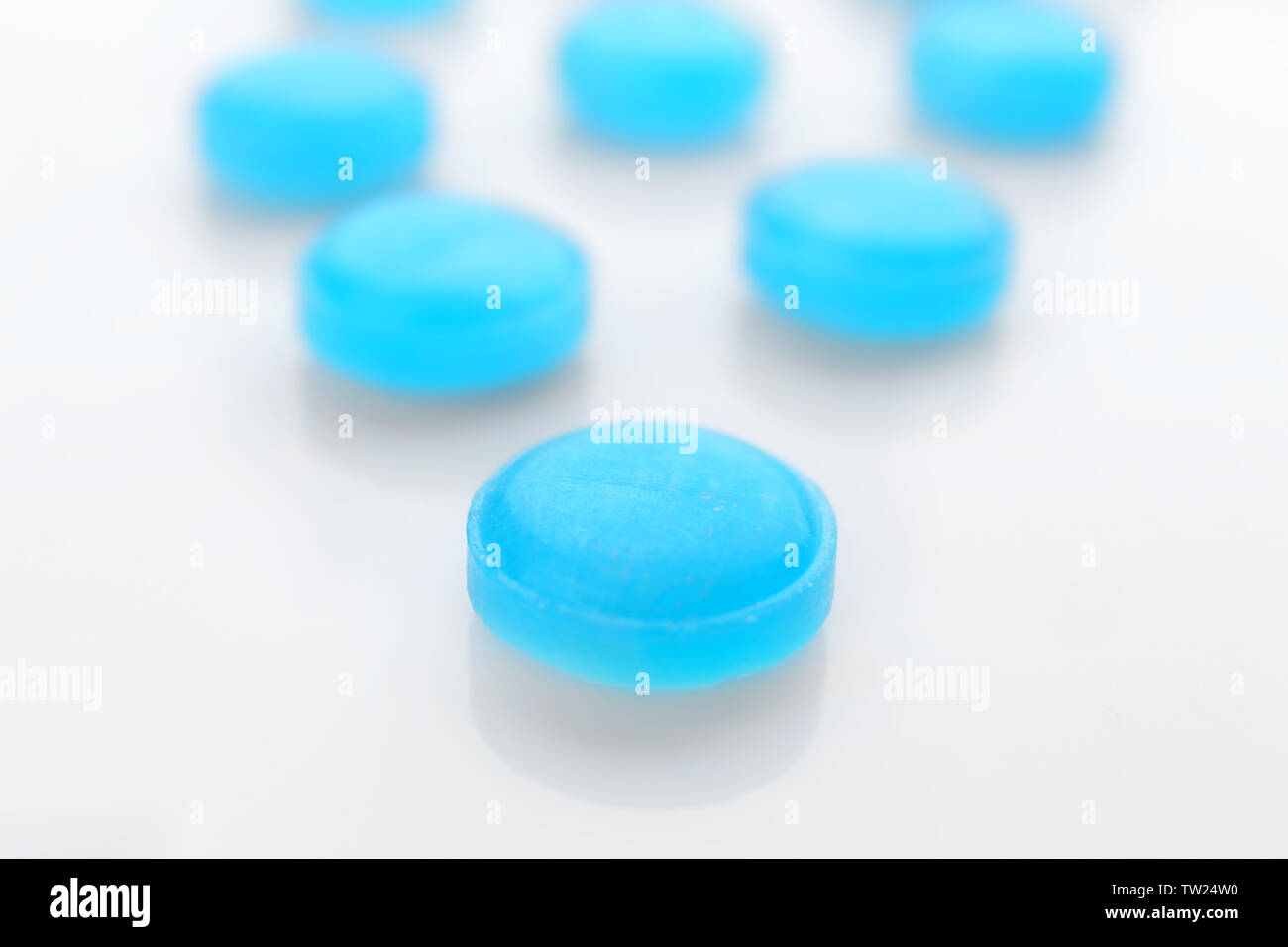 Cough drops on white background Stock Photo - Alamy
