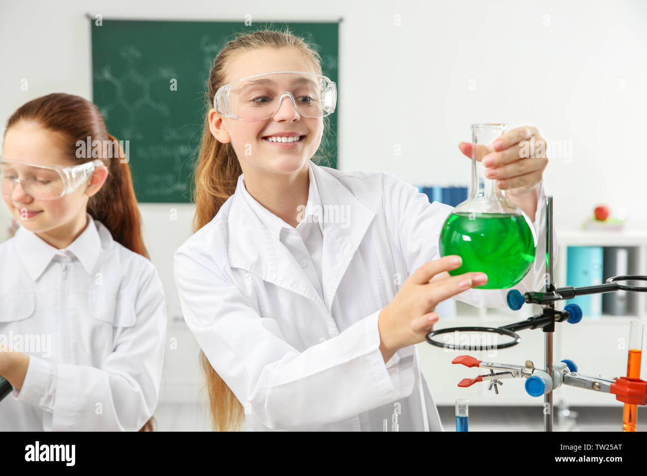 Beautiful scared school girl with flask in chemistry class Stock Photo ...