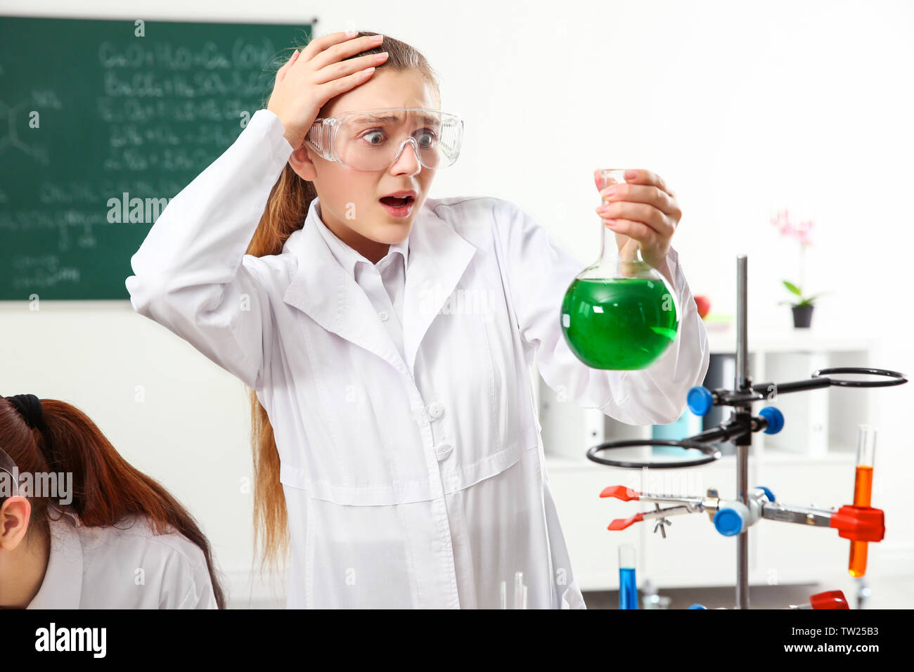 Beautiful scared school girl in chemistry class Stock Photo - Alamy