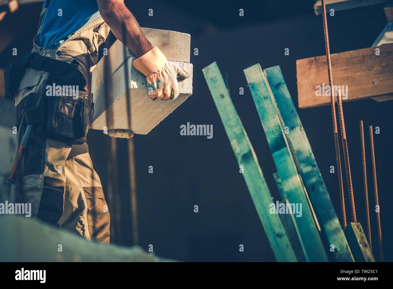 Strong Caucasian Construction Worker in His 30s Moving Concrete Blocks ...