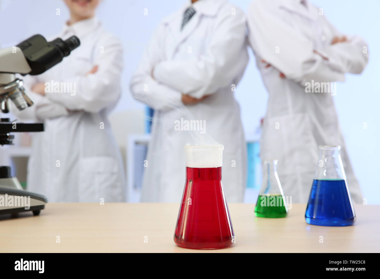 Flasks with reagents on desk in chemical class Stock Photo - Alamy