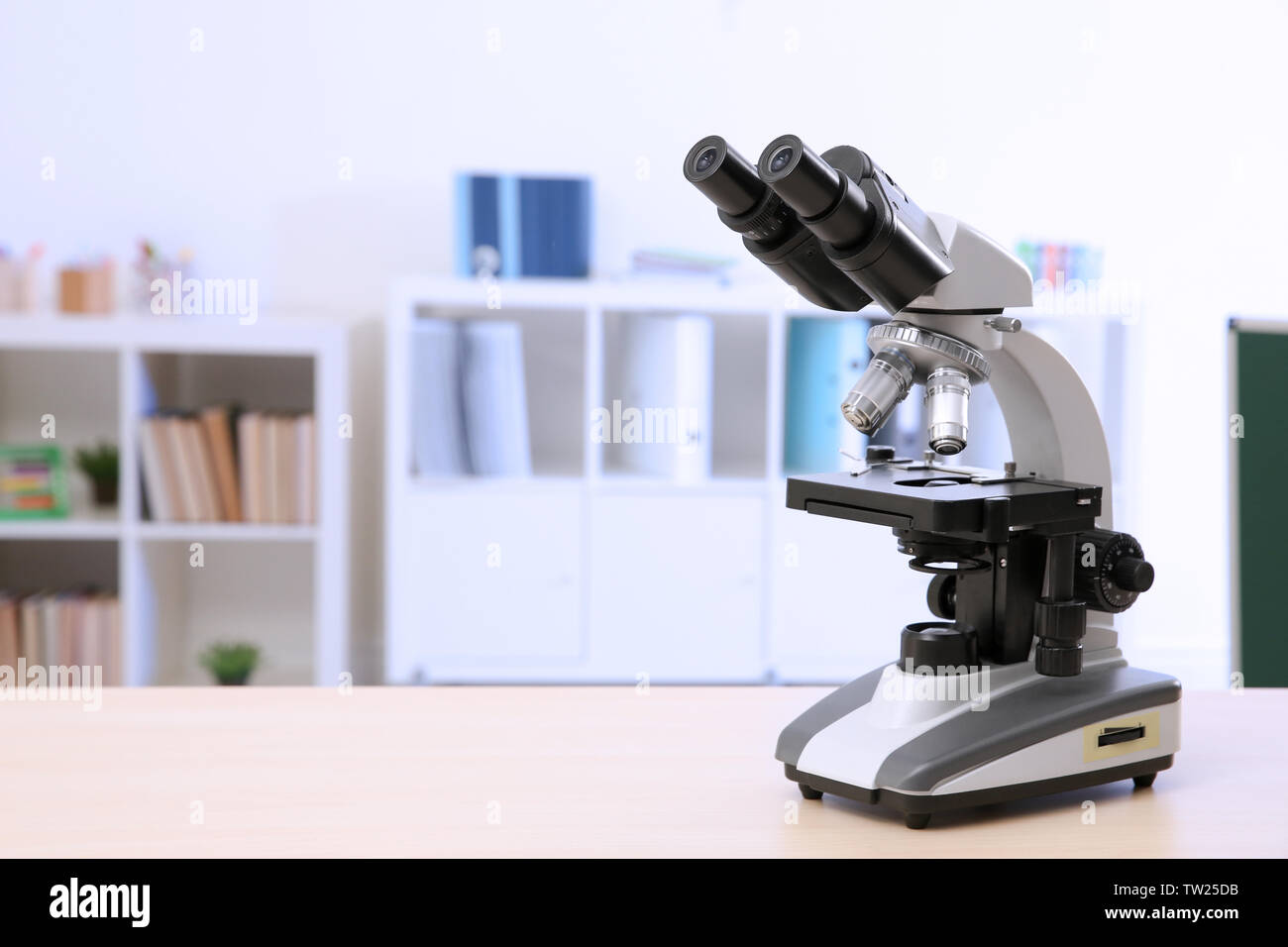 Microscope on table in chemistry class Stock Photo - Alamy