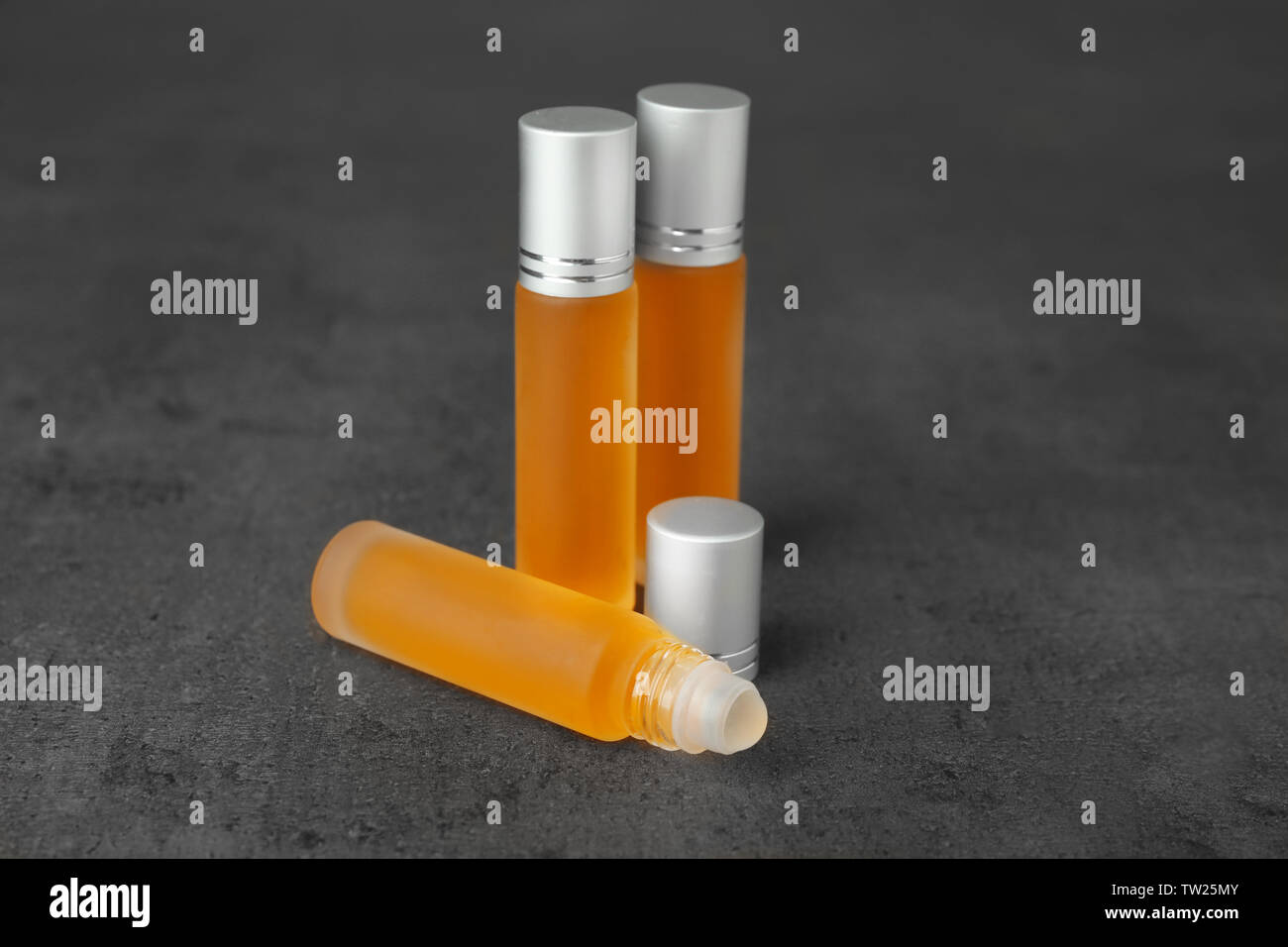 Bottles with perfume on grunge background Stock Photo - Alamy