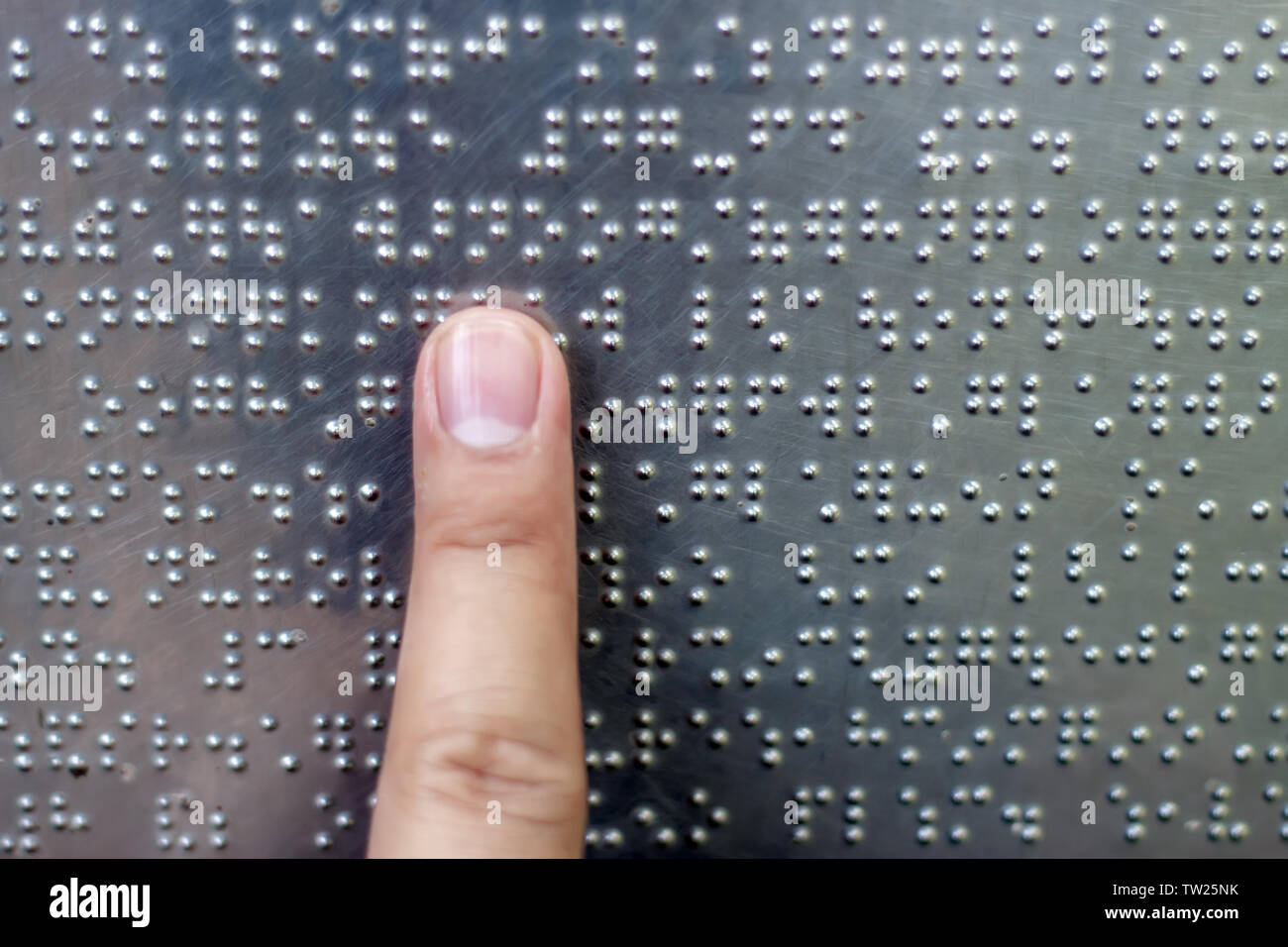 finger touch blind language on iron plate. reading communication with ...