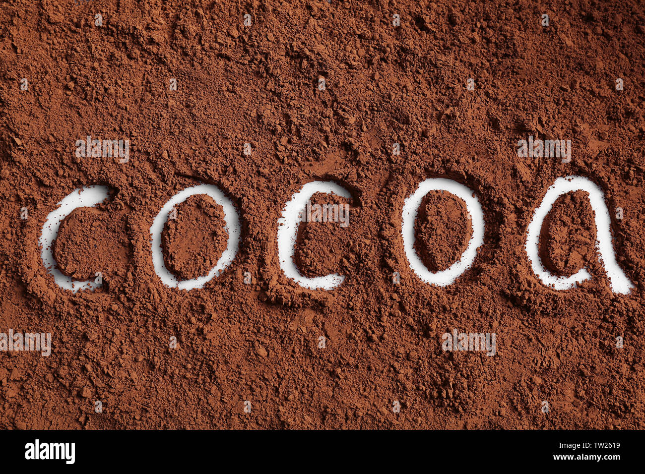 Word COCOA drawn on brown powder background Stock Photo - Alamy
