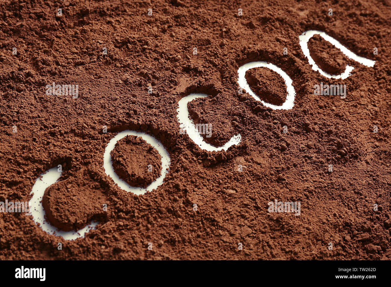 Word COCOA drawn on brown powder background Stock Photo - Alamy