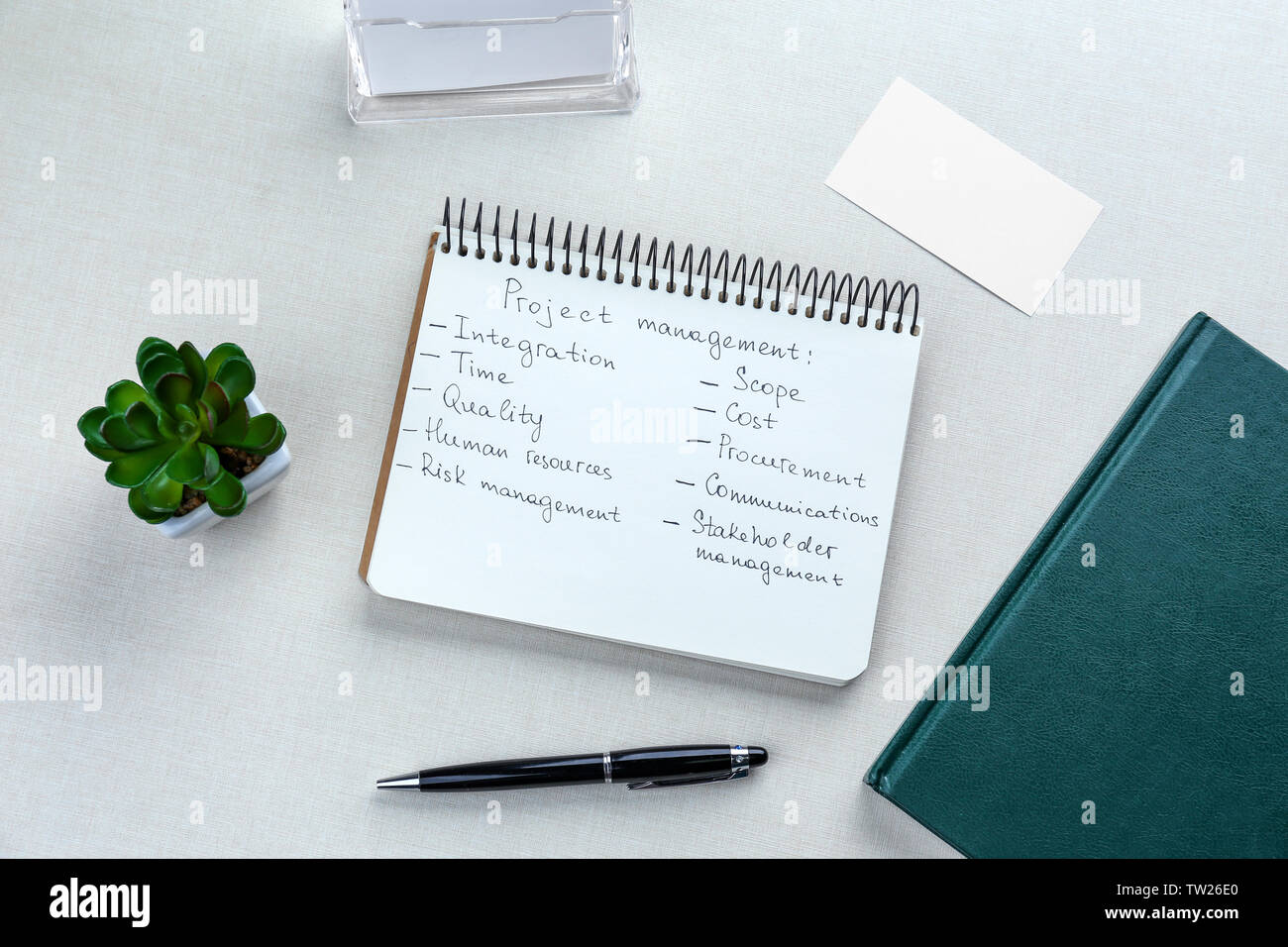 Notebook with written features of PROJECT MANAGEMENT on light ...