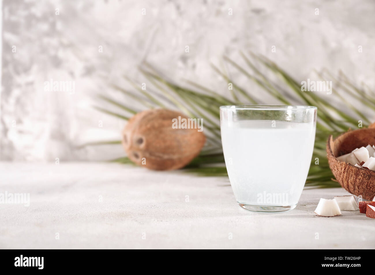 Glass of coconut water on table Stock Photo - Alamy