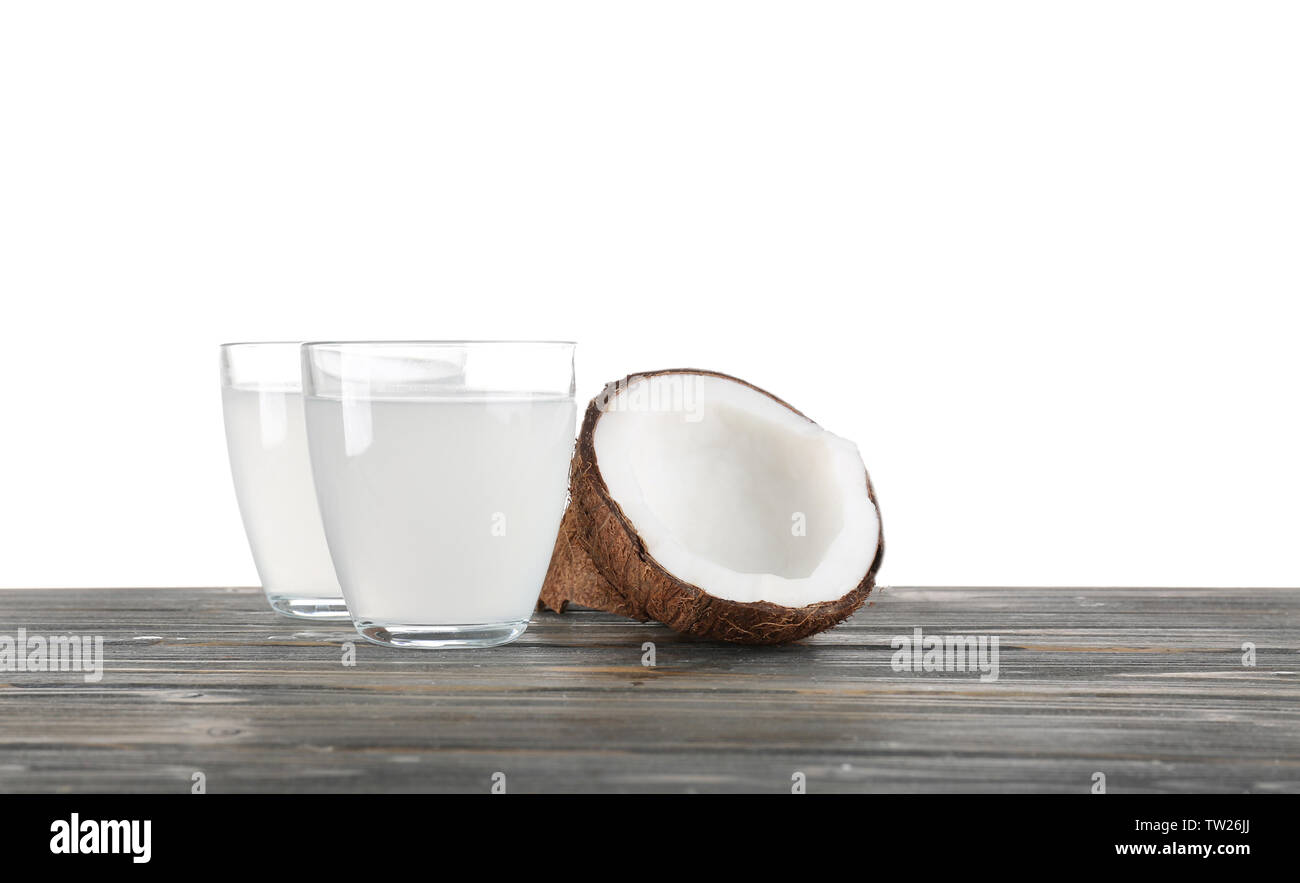 Two glasses of coconut water and fresh nut on white background Stock ...
