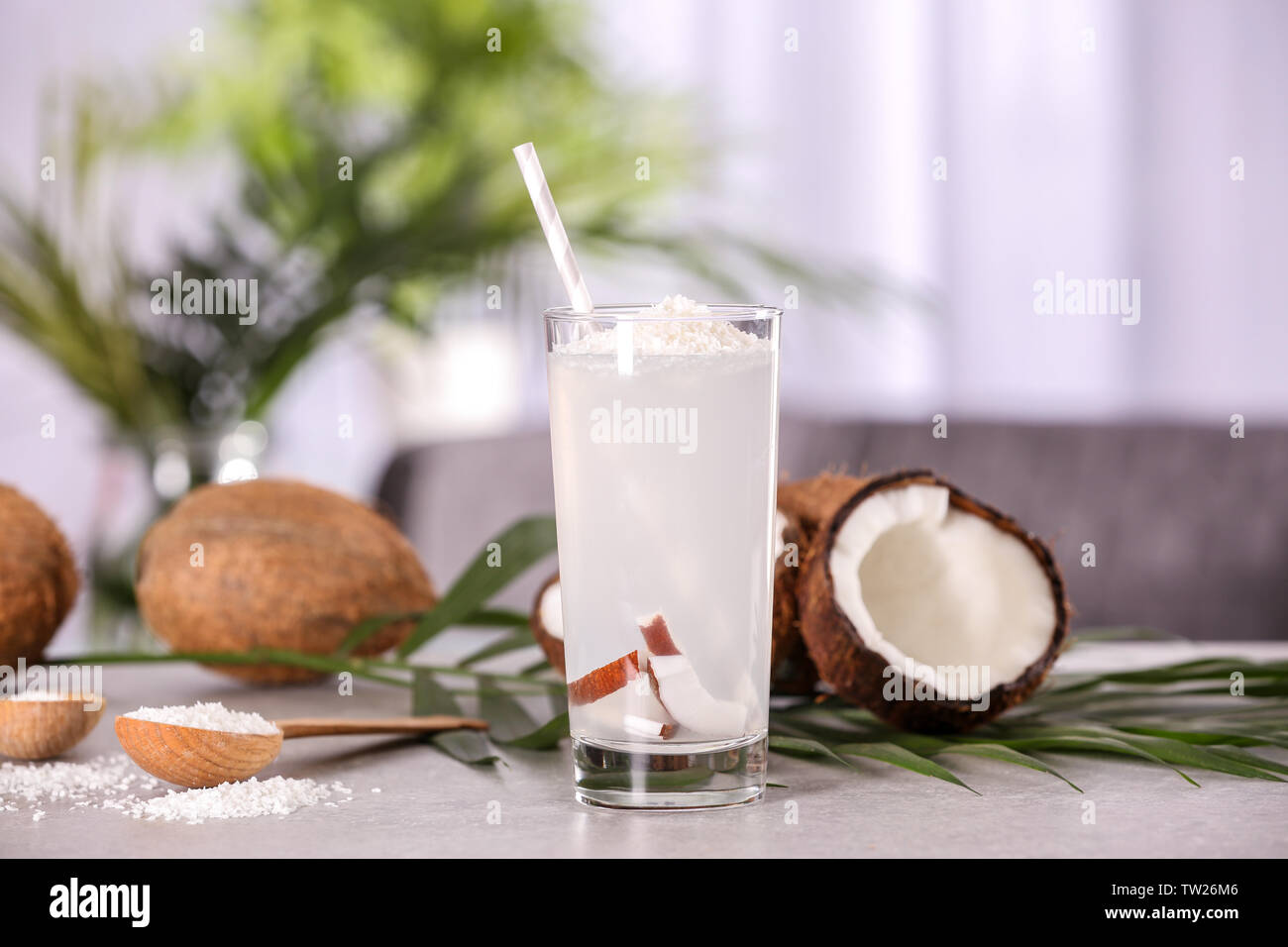 Glass of coconut water on table Stock Photo - Alamy