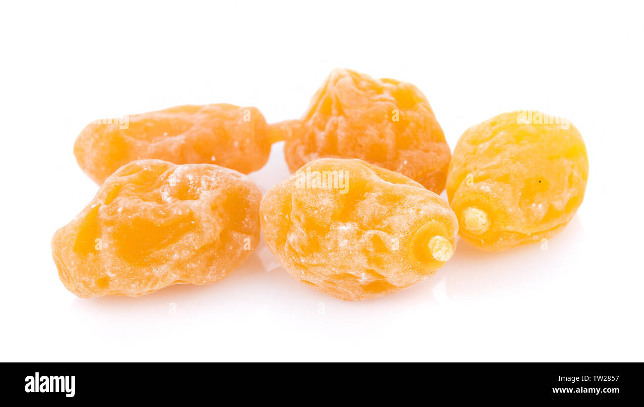 Dry yellow plums on white background Stock Photo - Alamy