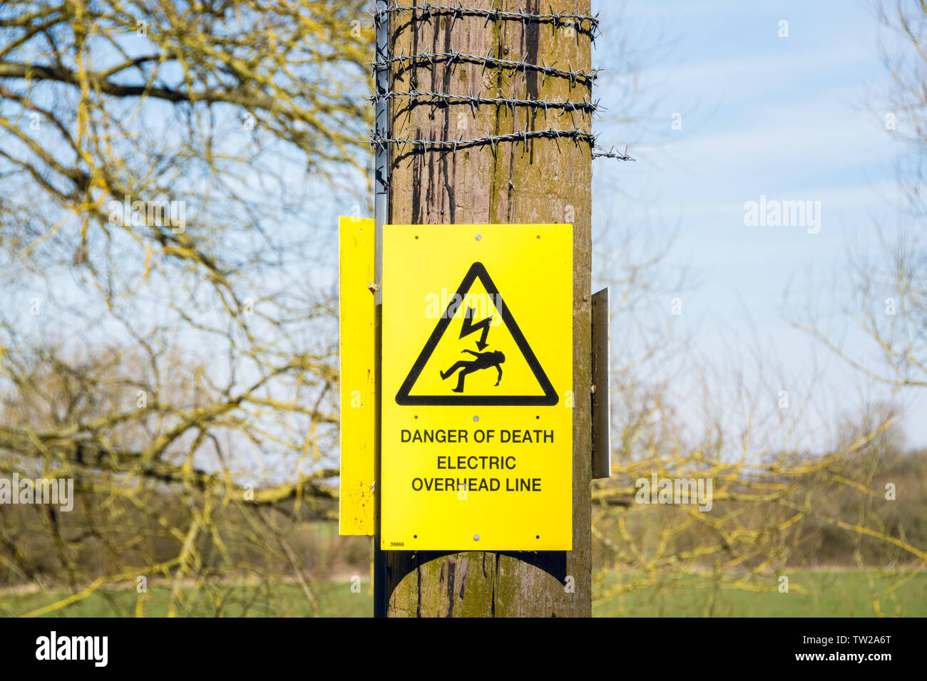 Warning sign on the pole of electric overhead power line - 2 Stock ...