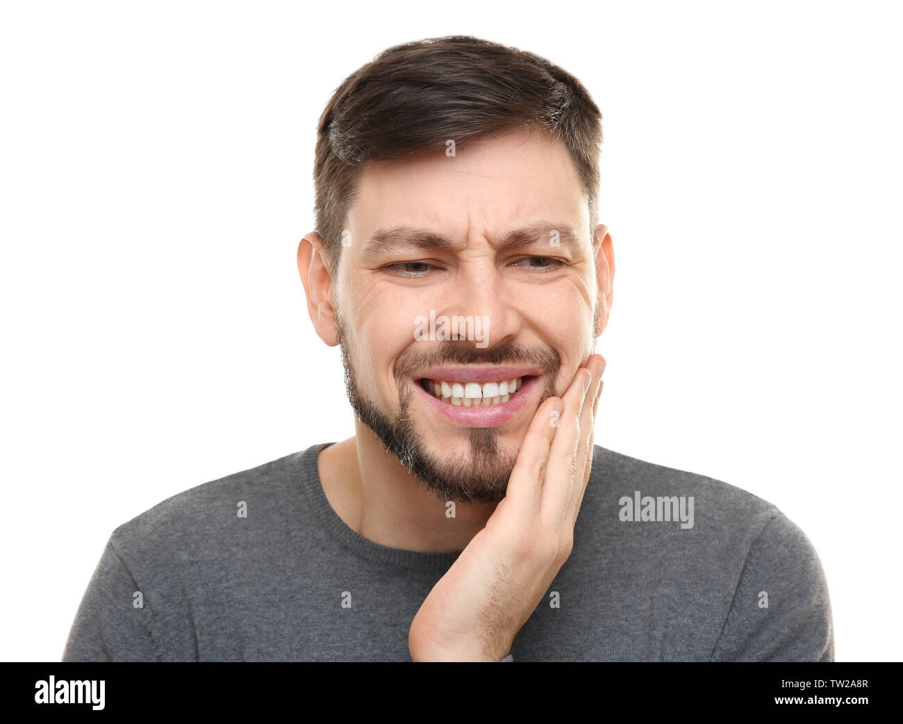 Handsome man suffering from toothache on white background Stock Photo ...