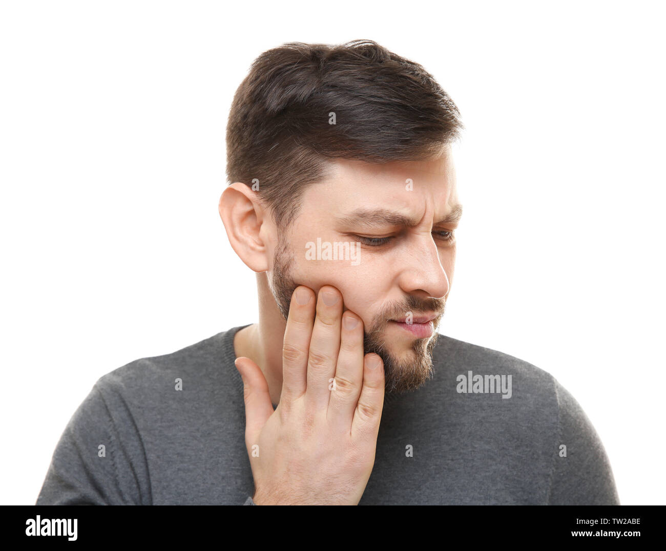 Handsome man suffering from toothache on white background Stock Photo ...