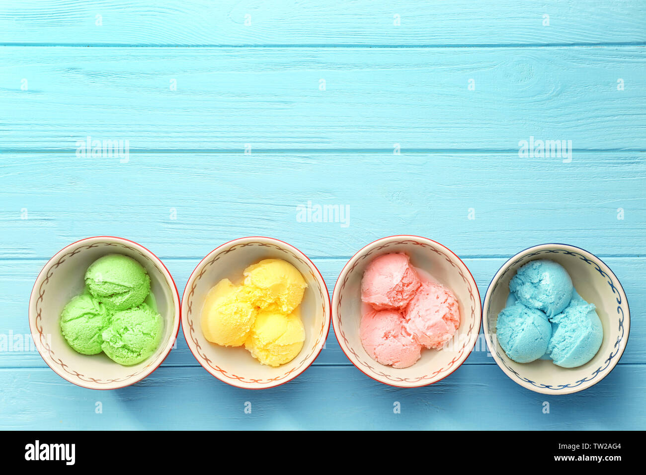 Ice cream collection in bowls on wooden background Stock Photo - Alamy