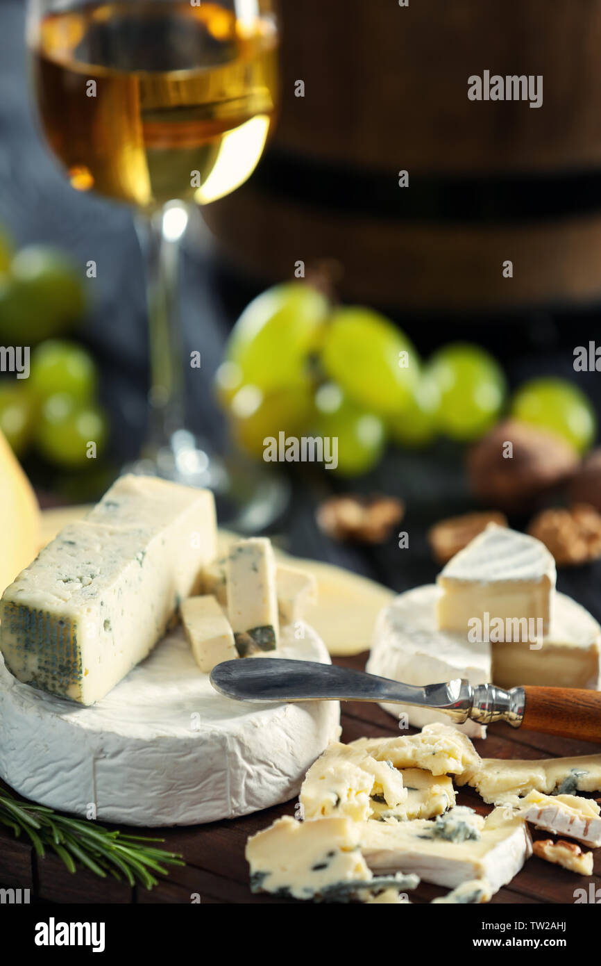 Different types of cheese with knife on blurred background Stock Photo ...