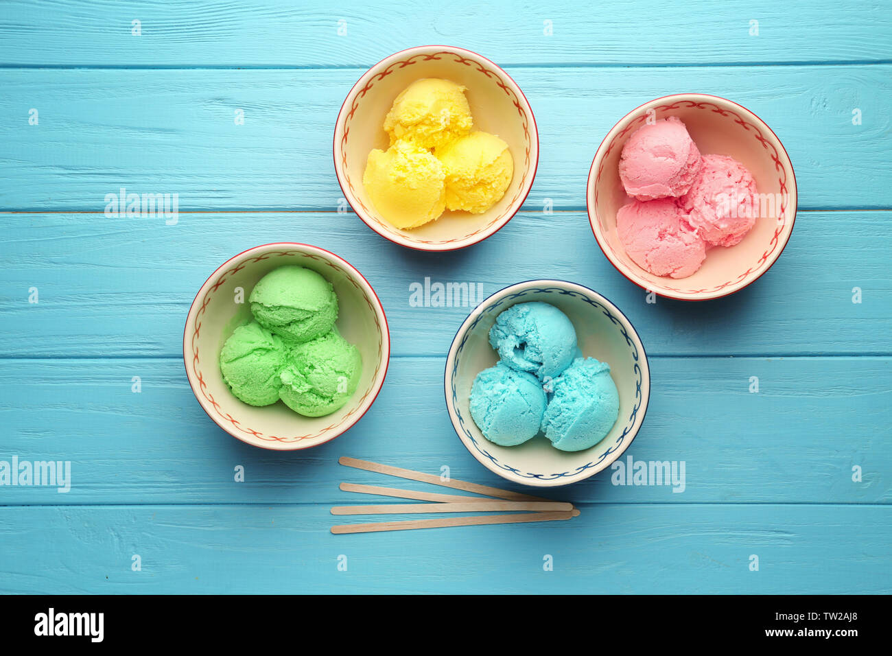 Ice cream collection in bowls on wooden background Stock Photo - Alamy