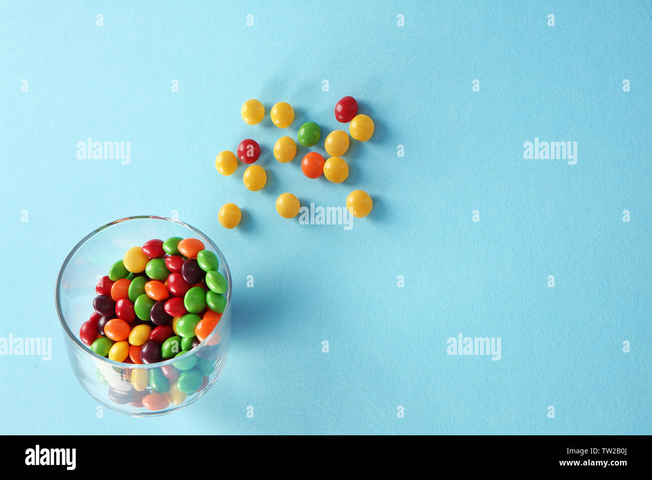 Delicious colorful candies in bowl on color background Stock Photo - Alamy