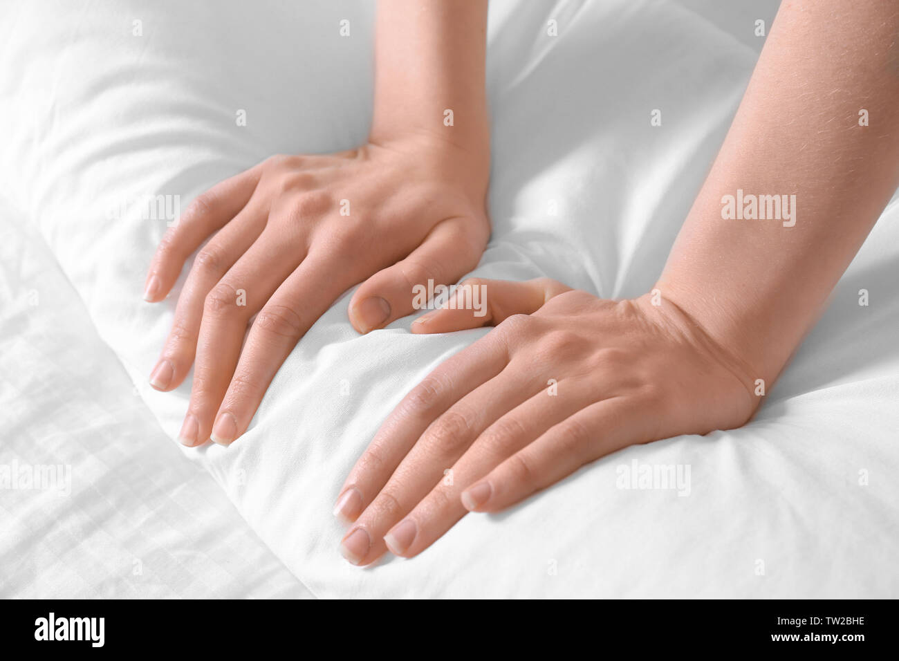 Female hand touching white orthopedic pillow. Healthy posture concept ...