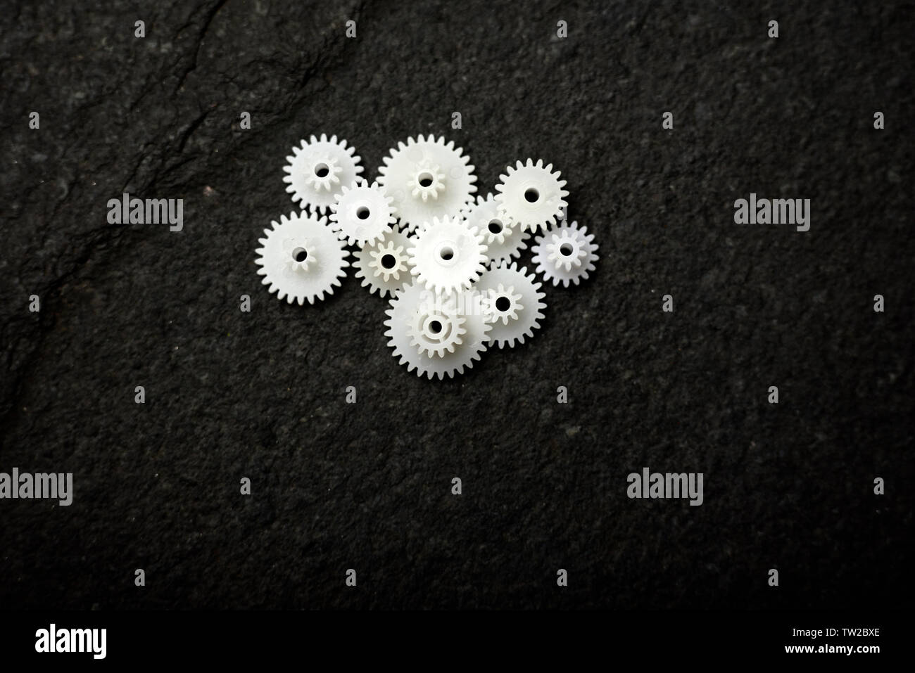 White wheel gears are on black texture background Stock Photo - Alamy