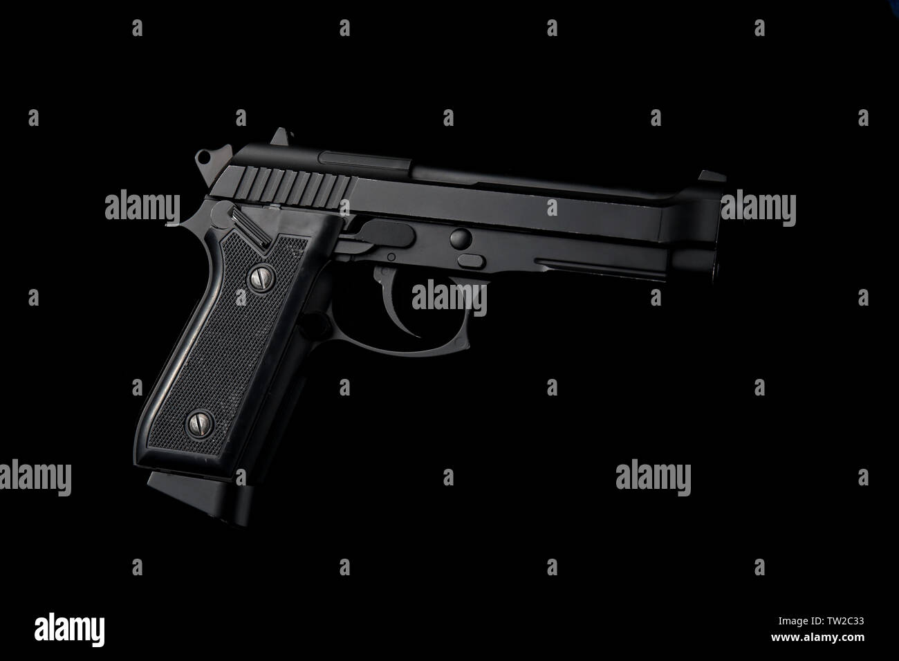 Gun on black background Stock Photo - Alamy