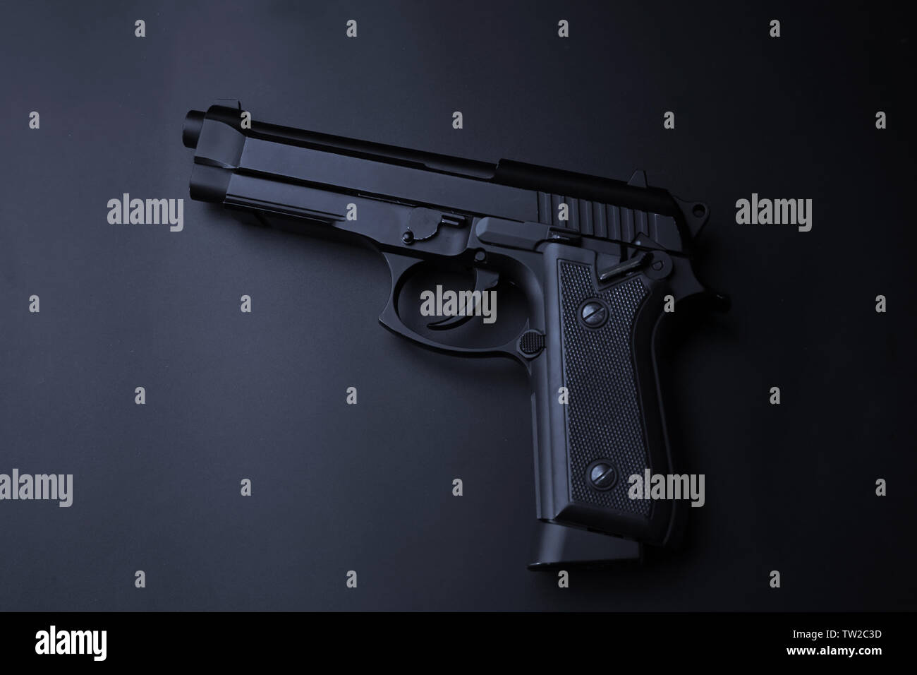 Gun on black background Stock Photo - Alamy