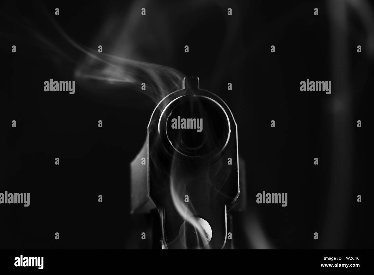 Smoking gun on black background Stock Photo - Alamy