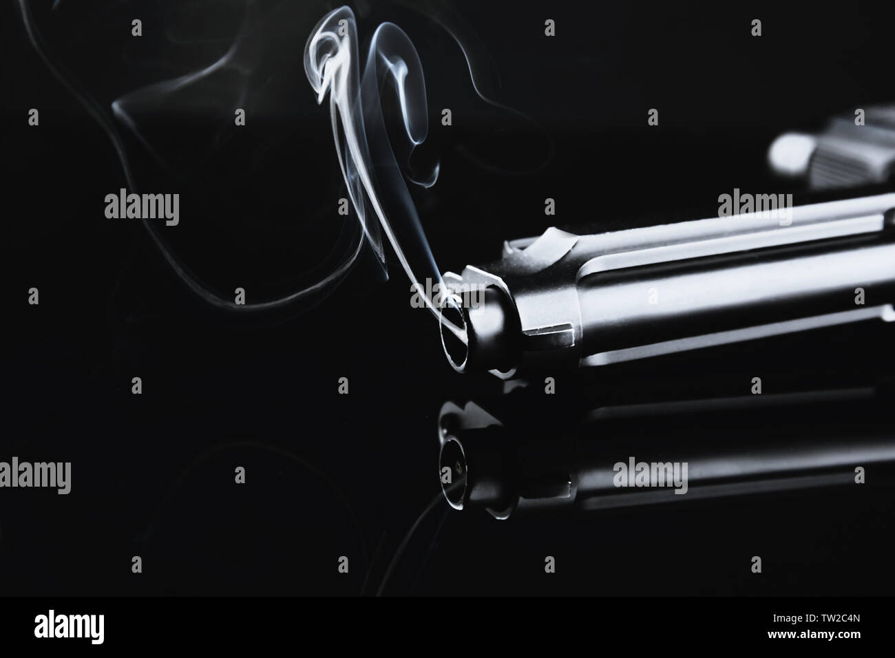 Smoking gun on black background Stock Photo - Alamy