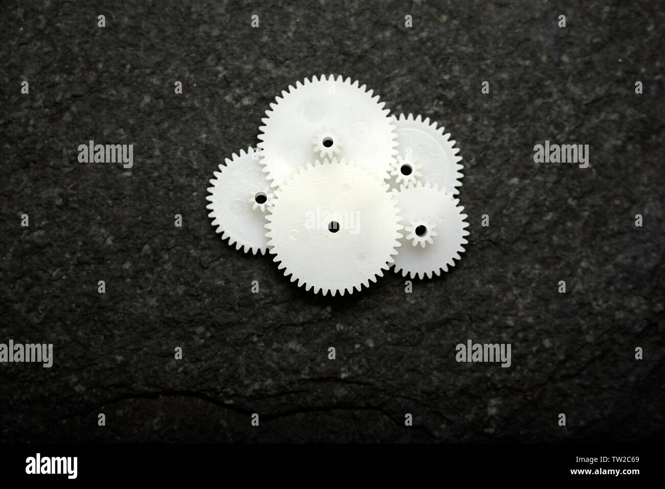 White wheel gears are on black texture background Stock Photo - Alamy