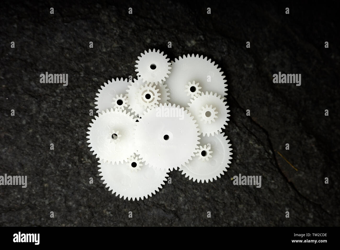 White wheel gears are on black texture background Stock Photo - Alamy