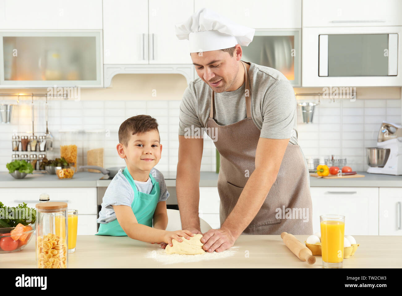Father and son cooking together in kitchen Stock Photo - Alamy