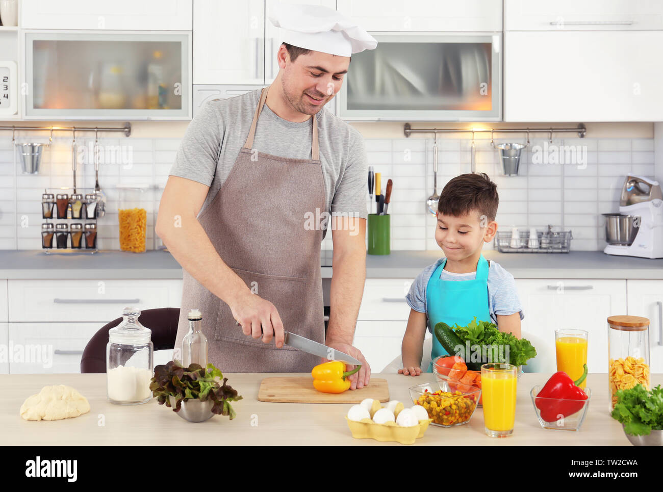 Father and son cooking together in kitchen Stock Photo - Alamy
