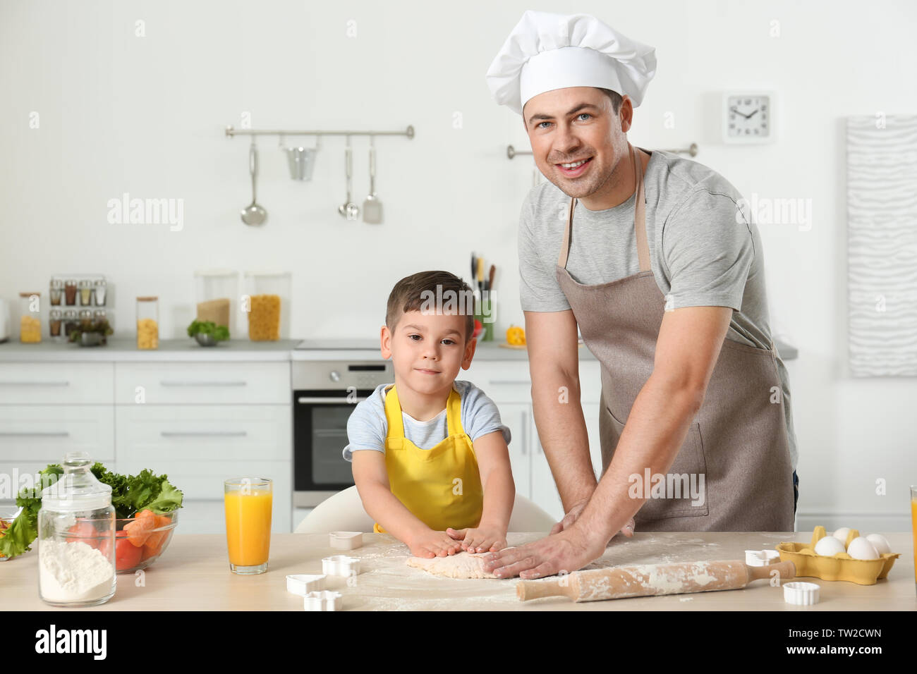 Father and son cooking together in kitchen Stock Photo - Alamy
