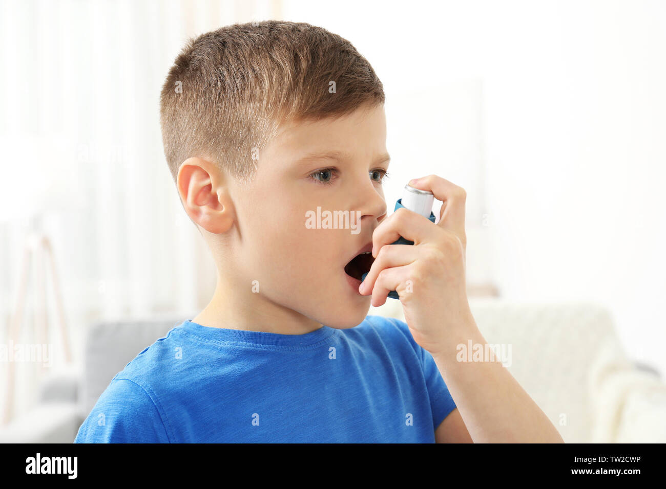 Little boy using asthma inhaler at home Stock Photo - Alamy