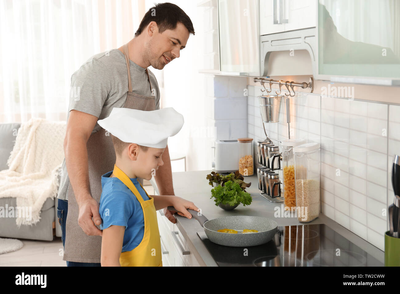 Father and son cooking together in kitchen Stock Photo - Alamy