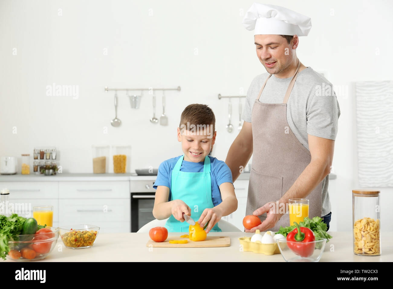 Father and son cooking together in kitchen Stock Photo - Alamy