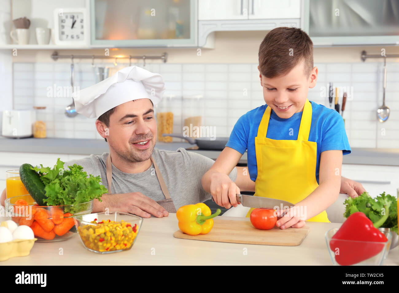 Father and son cooking together in kitchen Stock Photo - Alamy